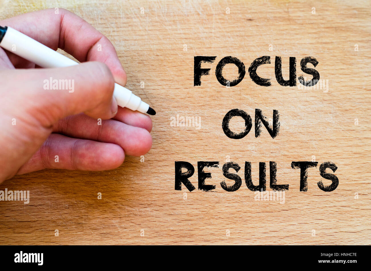 Human hand over wooden background and focus on results text concept ...