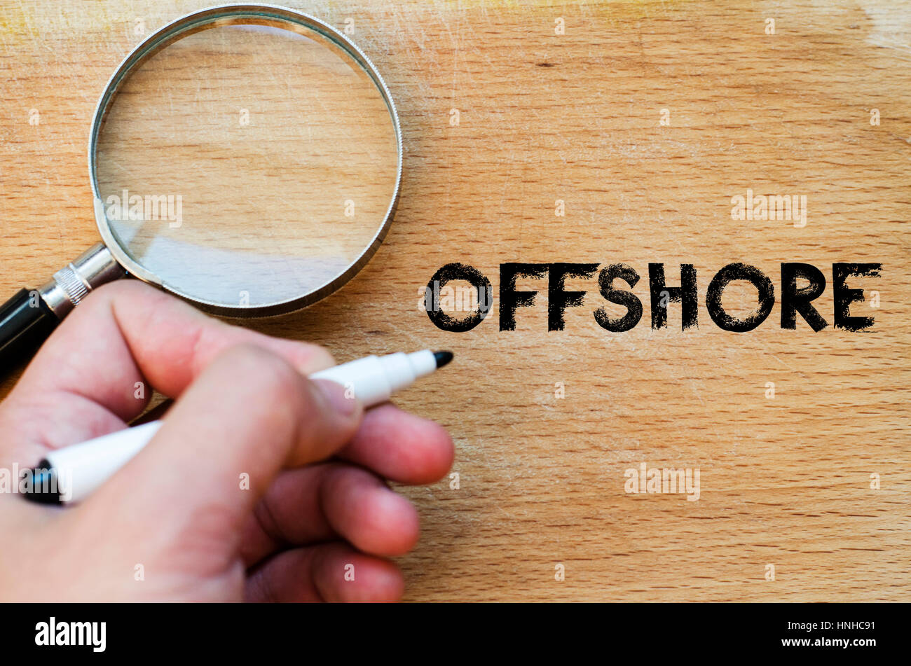 Human hand over wooden background and offshore text concept Stock Photo ...