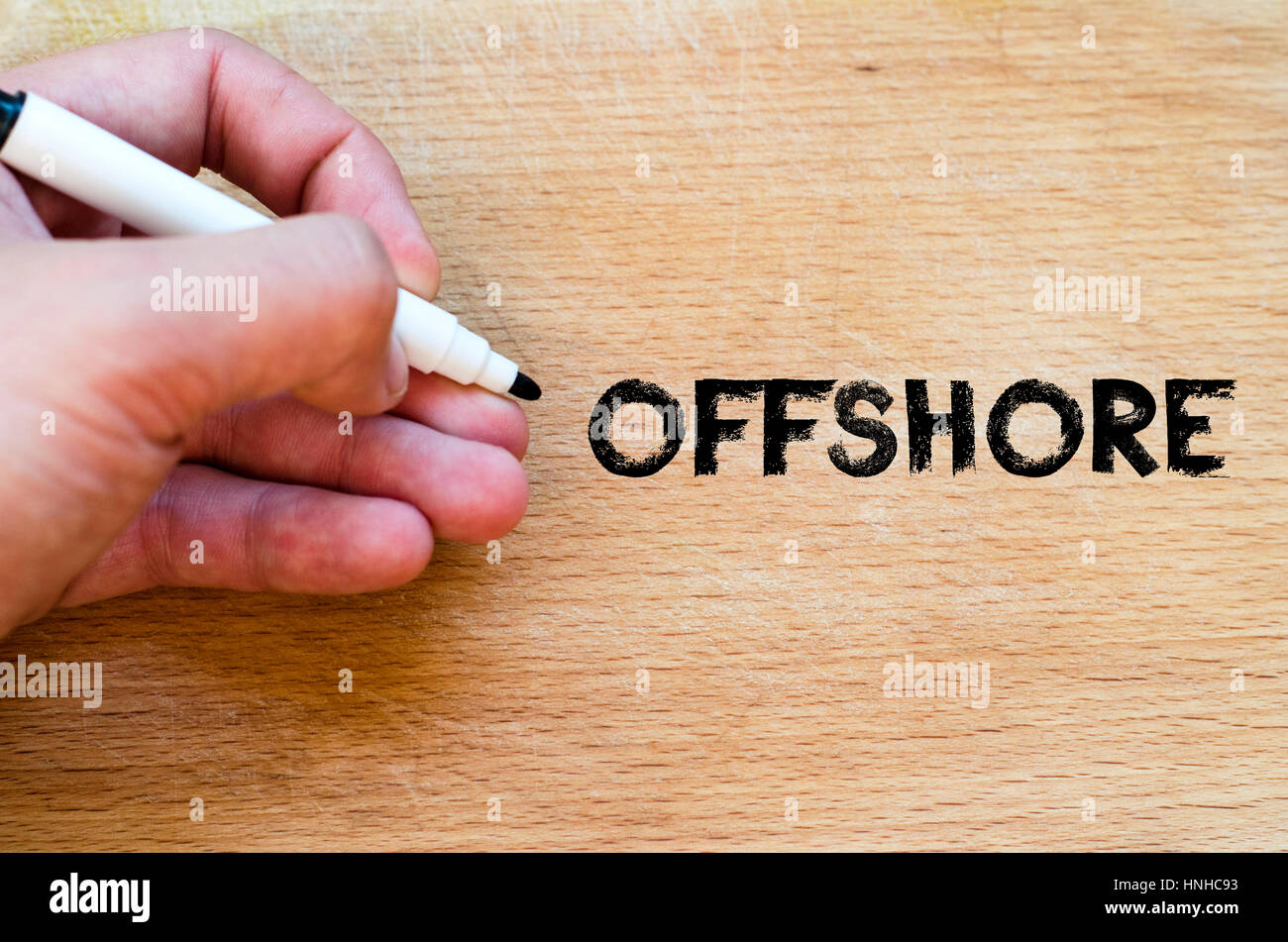 Human hand over wooden background and offshore text concept Stock Photo ...
