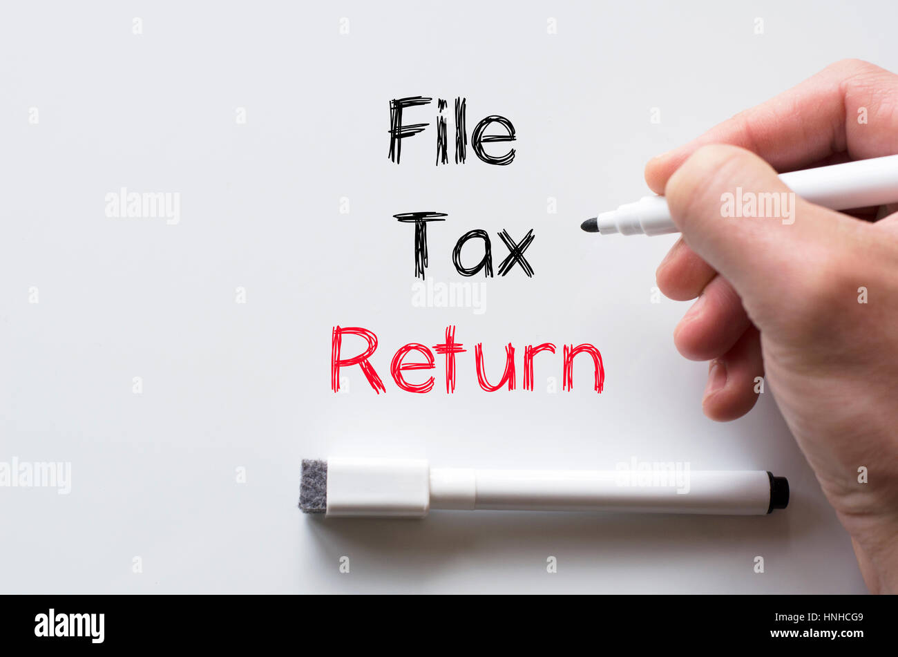Human hand writing file tax return on whiteboard Stock Photo - Alamy