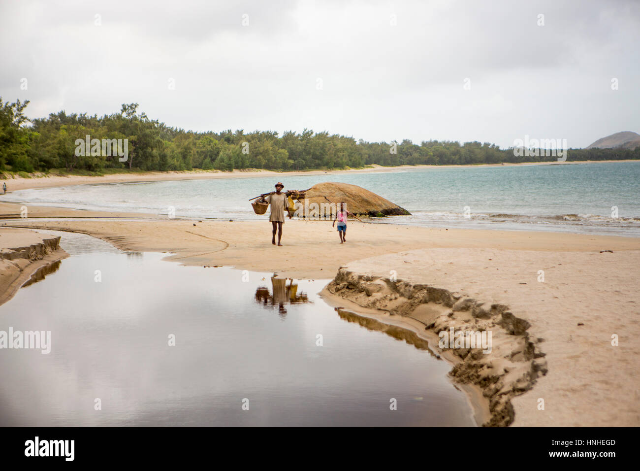 Father and his little son returning from his morning catch at the sea ...