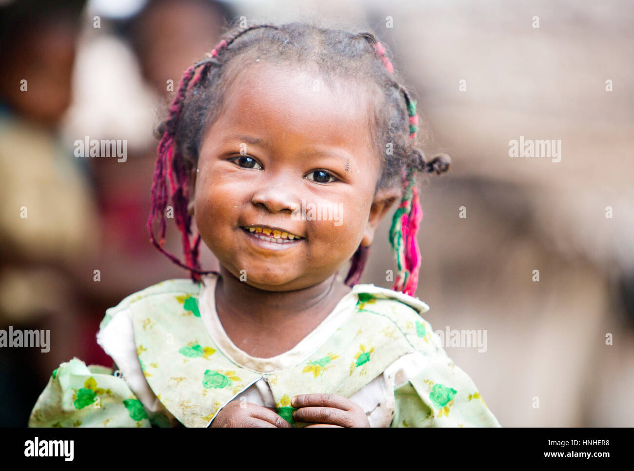 Smiling portrait of a little girl taken in rural fisherman's community ...