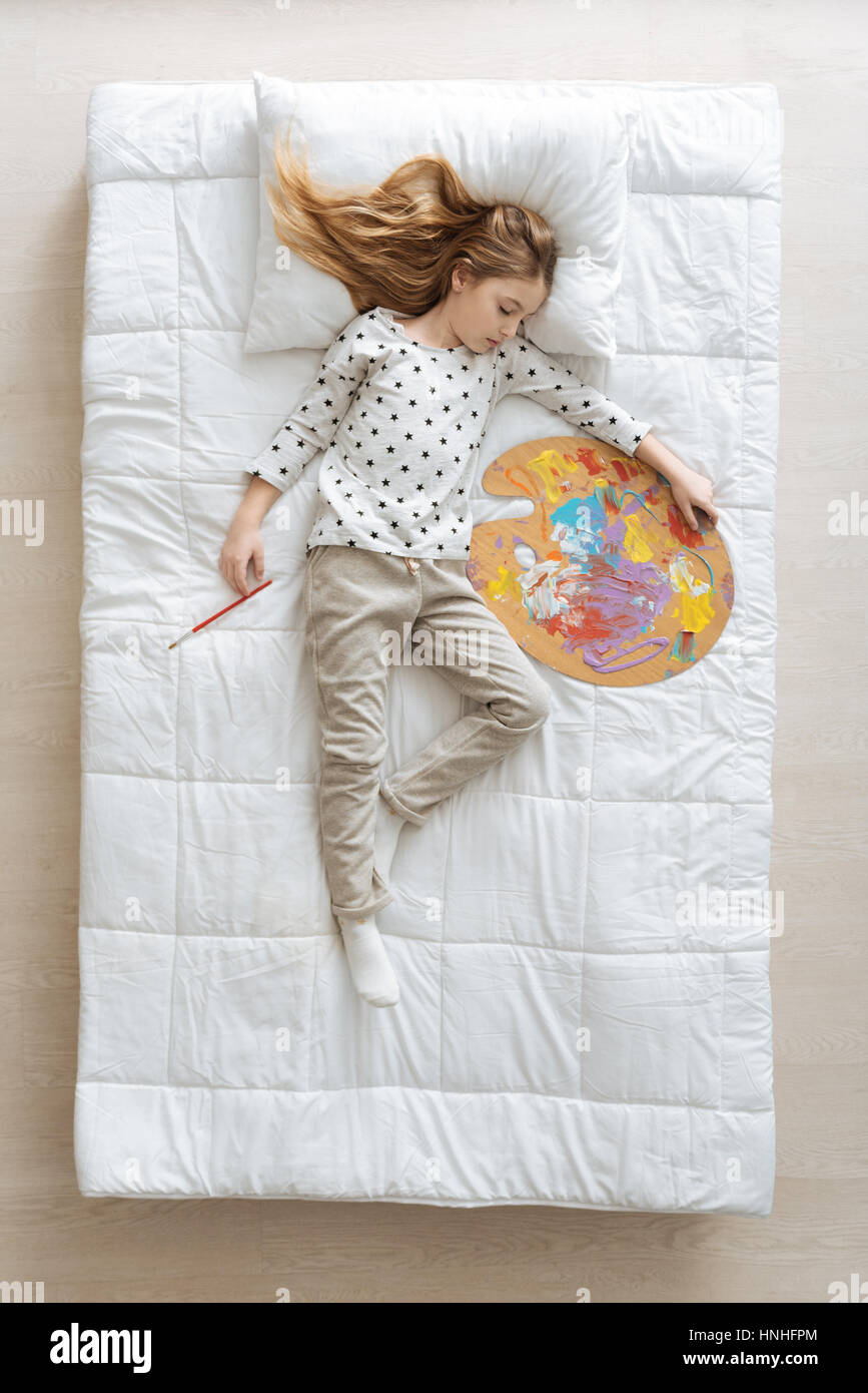 Cute young artist having a nap Stock Photo - Alamy