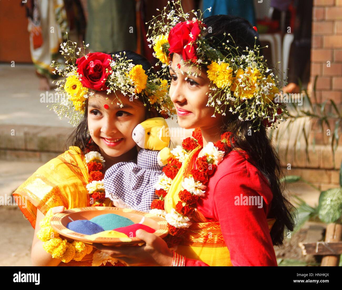 Dhaka, Bangladesh. 13th Feb, 2017. Two girls wearing flower decorations ...