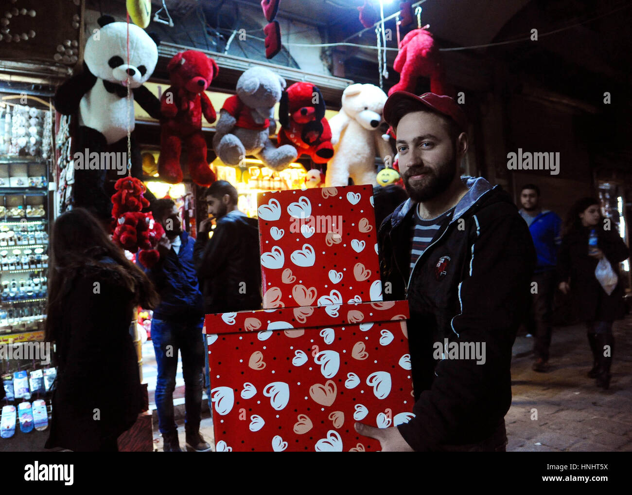 Damascus. 13th Feb, 2017. A Syrian man carries two gift boxes he bought ...
