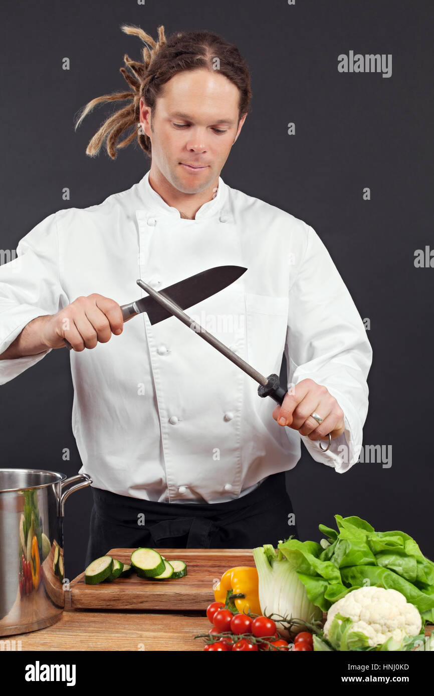 Photo of a chef with dreadlocks sharpening his chopping knife Stock ...
