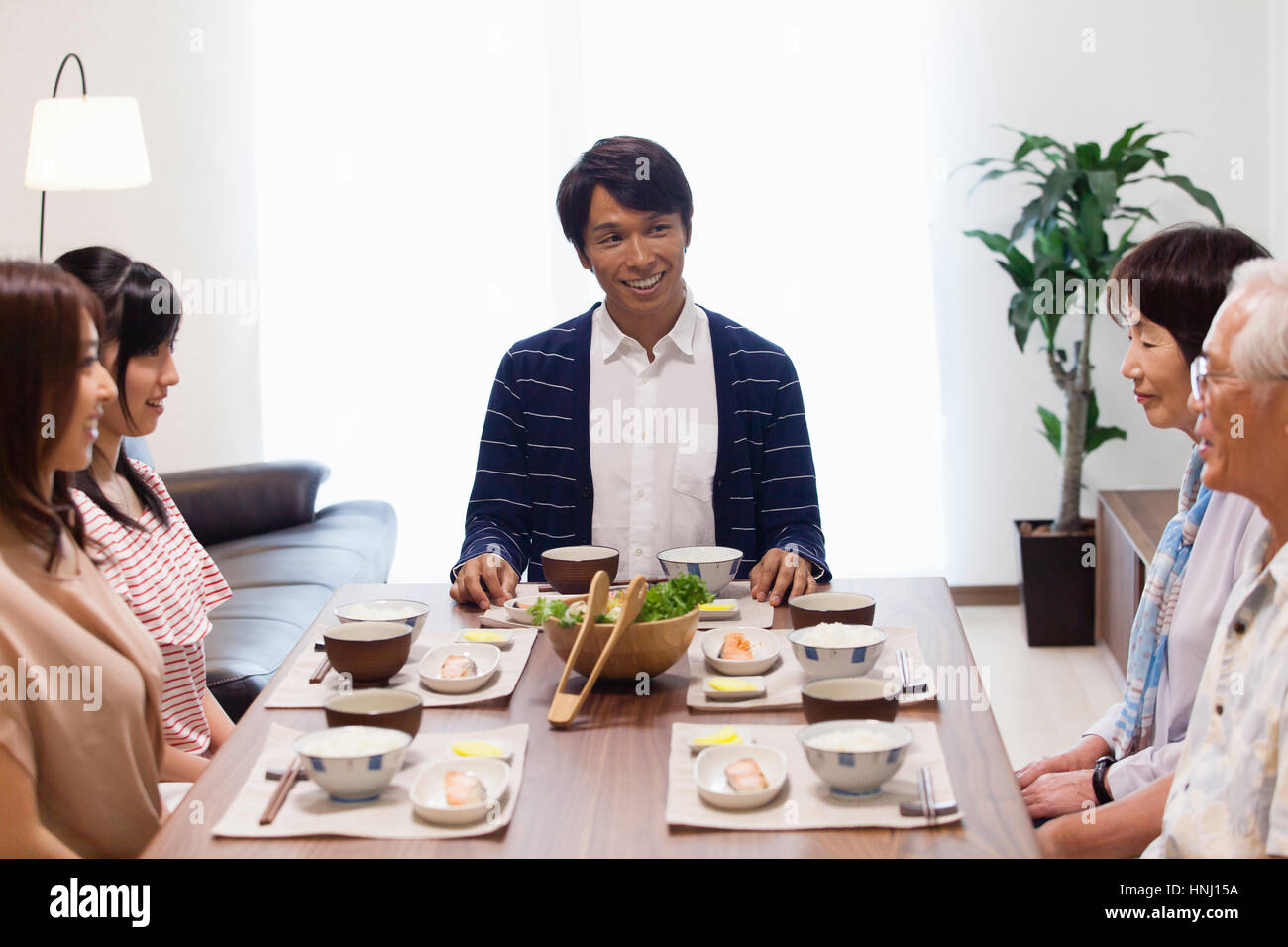 Three generation family at a dining table Stock Photo - Alamy