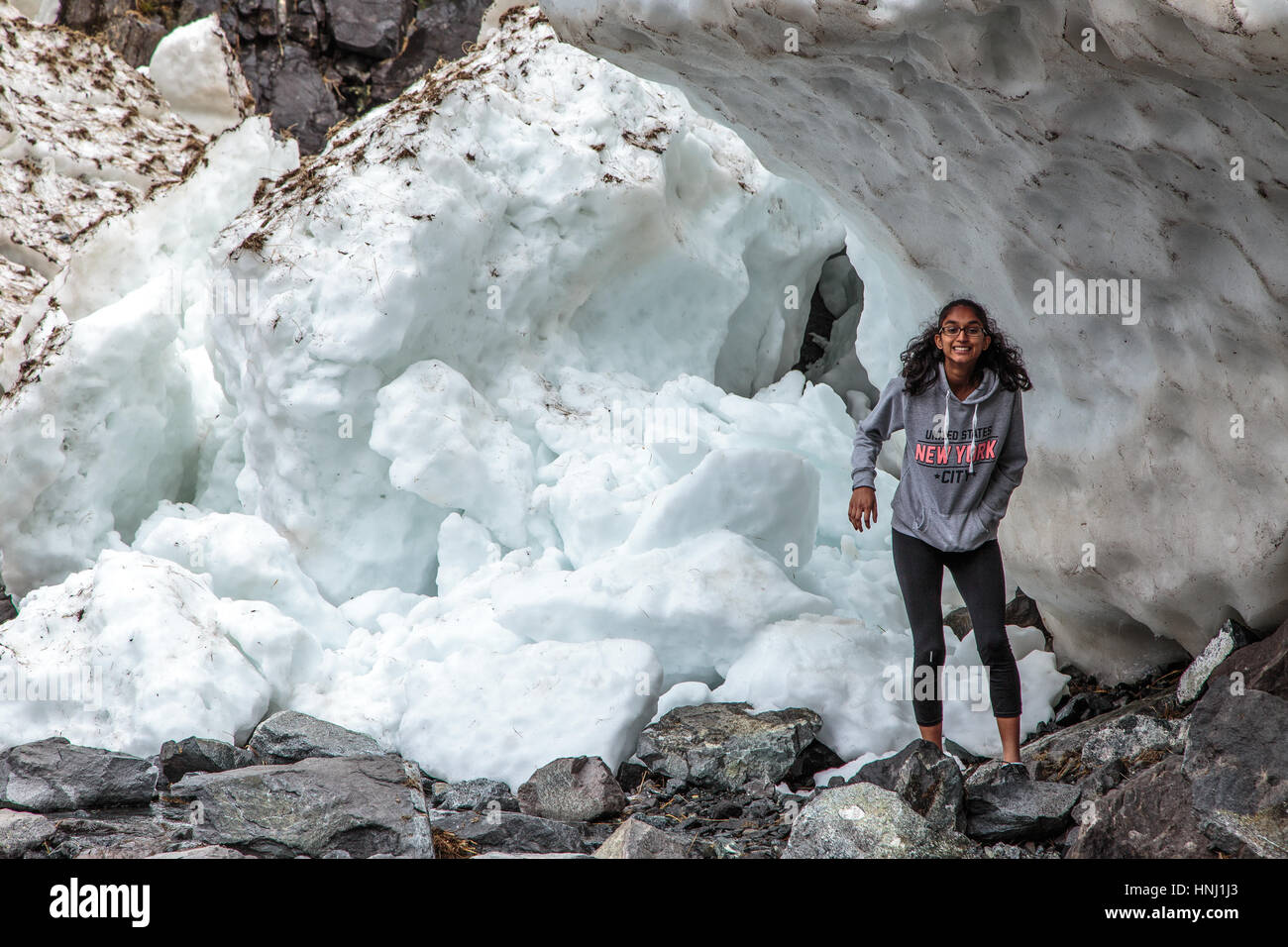 Girl under glacier Stock Photo - Alamy