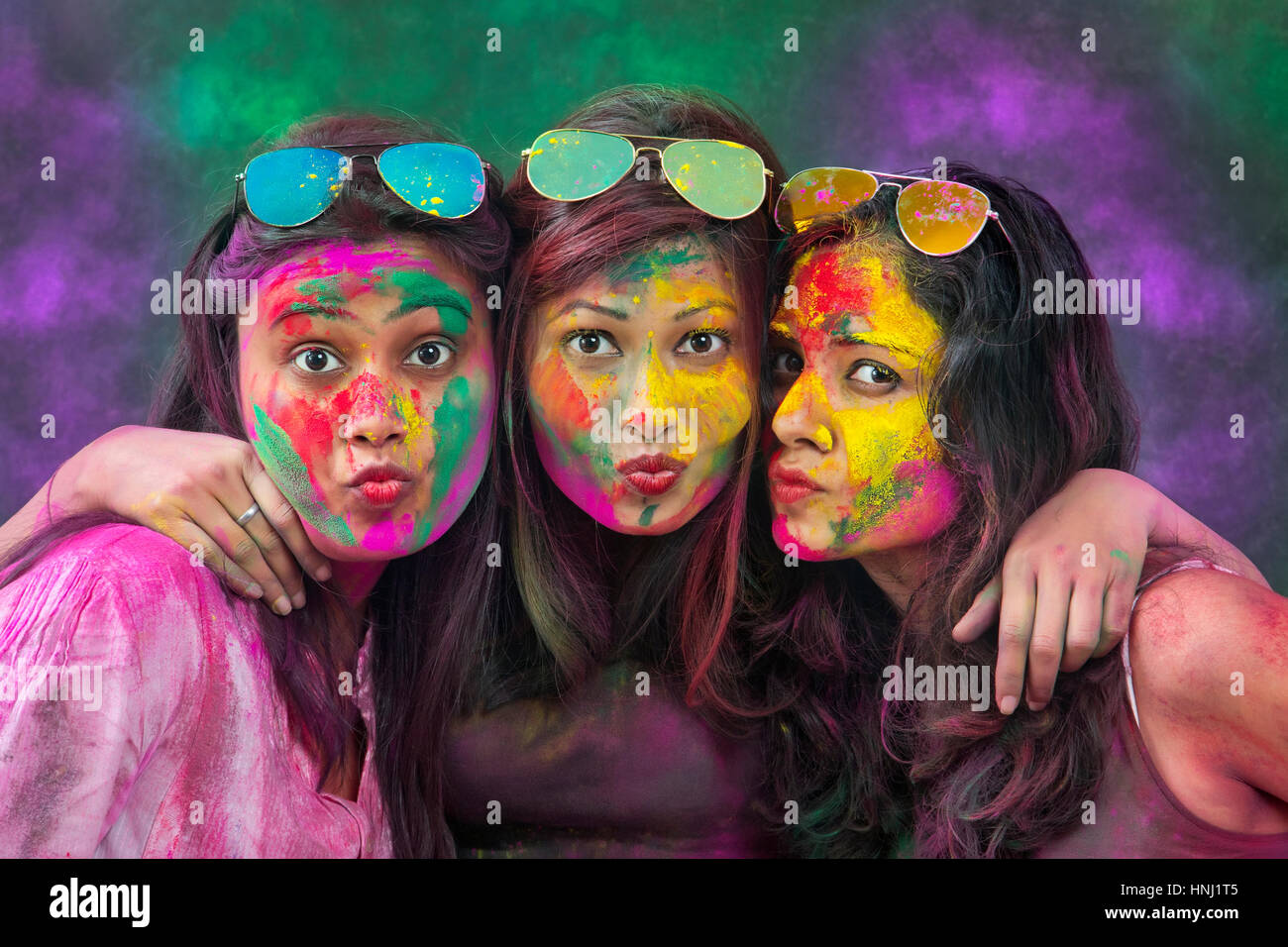 Portrait Of Three Young Indian Women With Colored Face Dancing During ...
