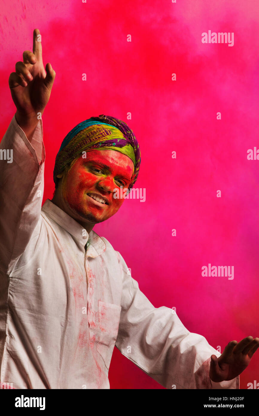 Young Indian man With Colored Face Dancing During Holi Color festival ...