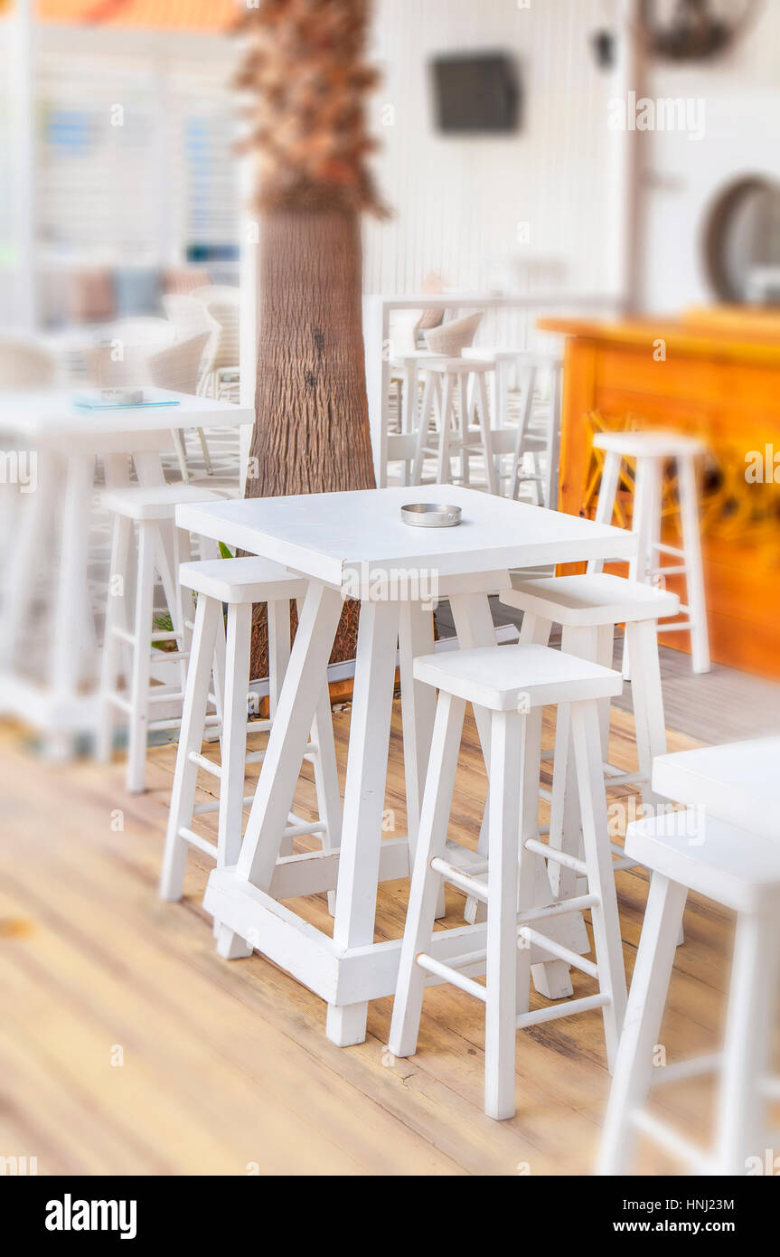Wooden high siting table in beach club open Stock Photo - Alamy