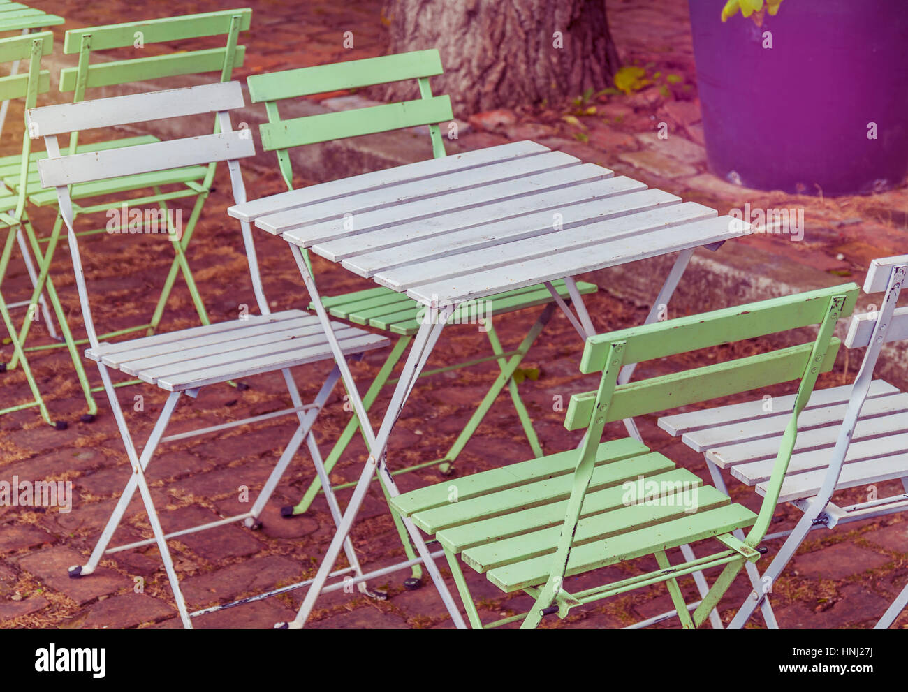 Wooden table and chair in the cafe garden Stock Photo - Alamy