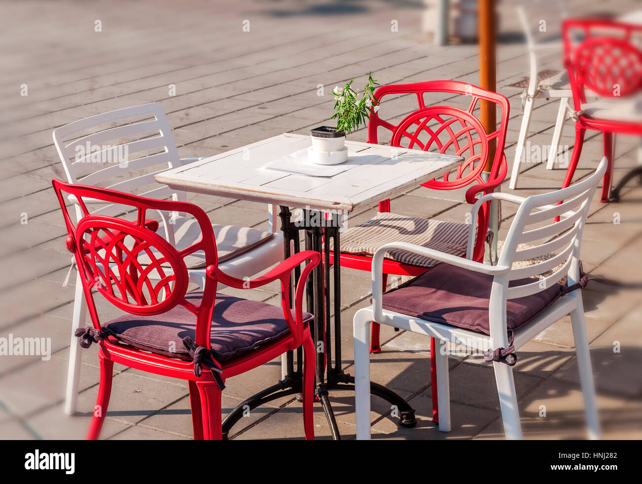 Wooden table and chair in the cafe garden Stock Photo - Alamy