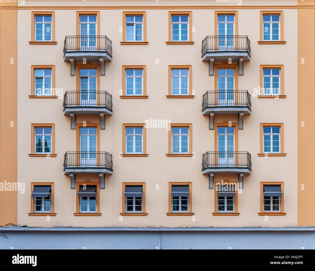 Modern orange building with windows Stock Photo - Alamy