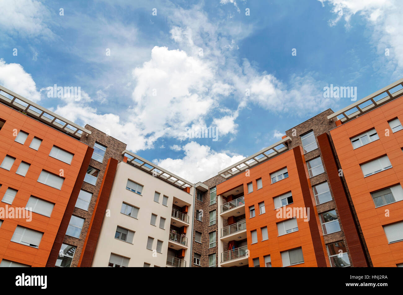 New block of modern apartments and blue sky Stock Photo - Alamy