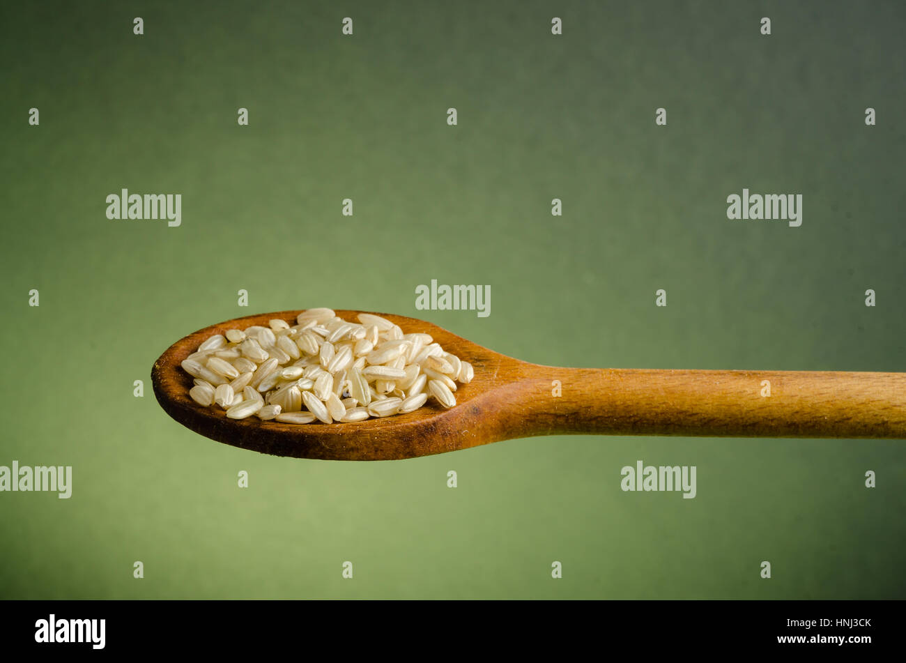 rice in a spoon, close up, color background Stock Photo - Alamy