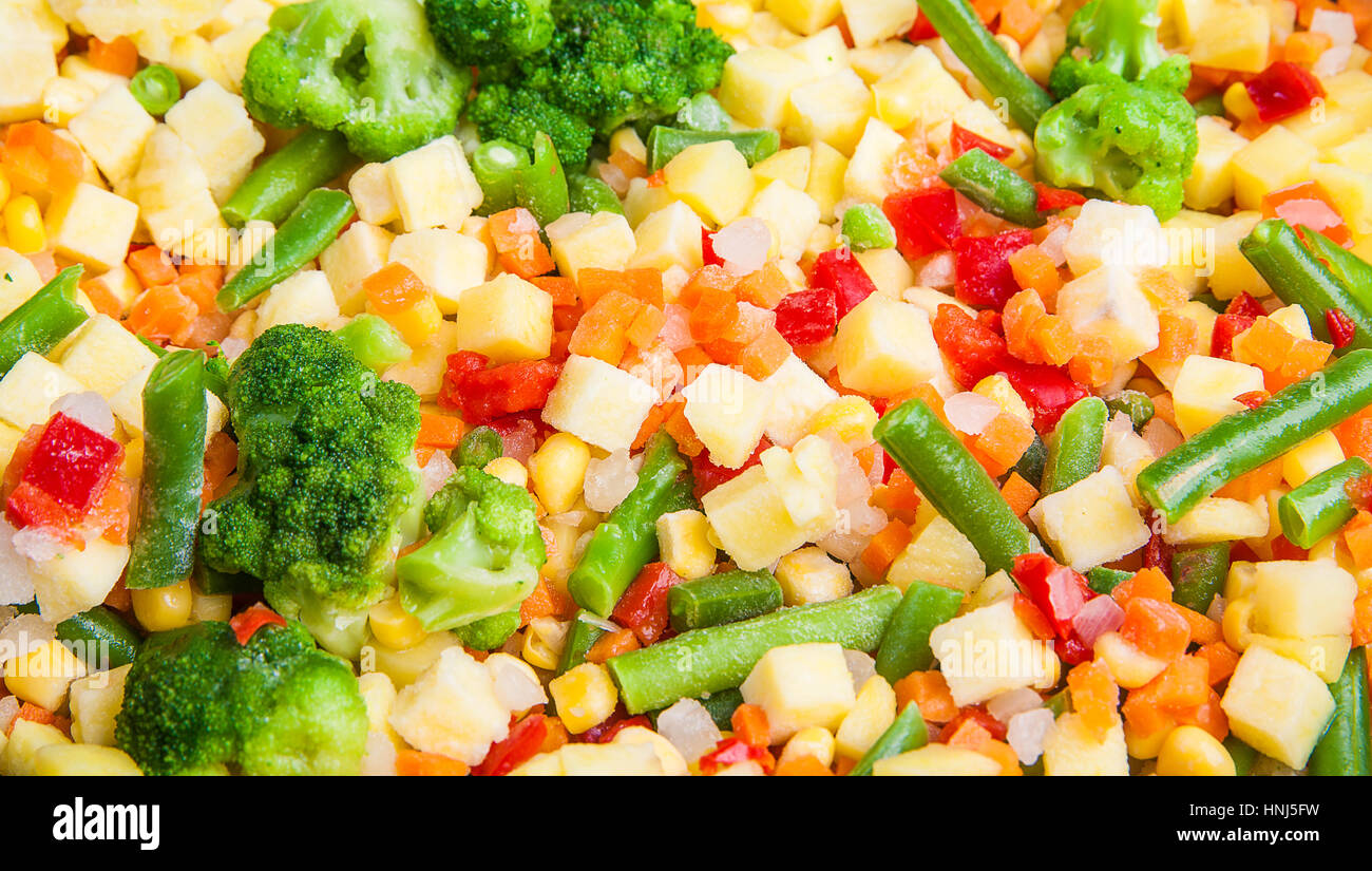 A cocktail of frozen chopped vegetables close-up as background Stock ...