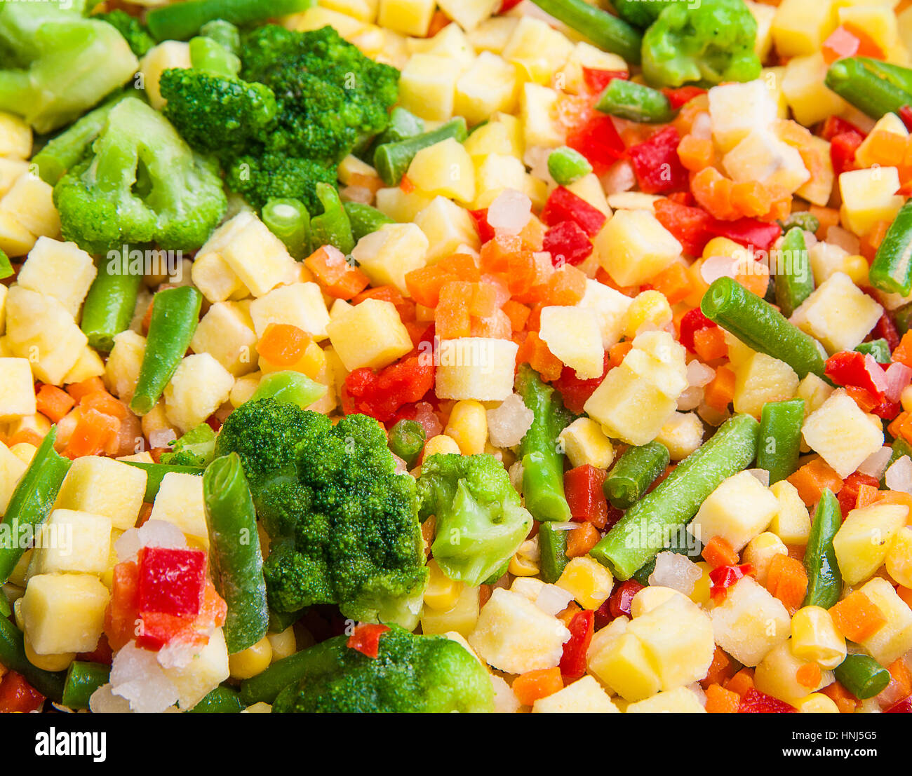 A cocktail of frozen chopped vegetables close-up as background Stock ...