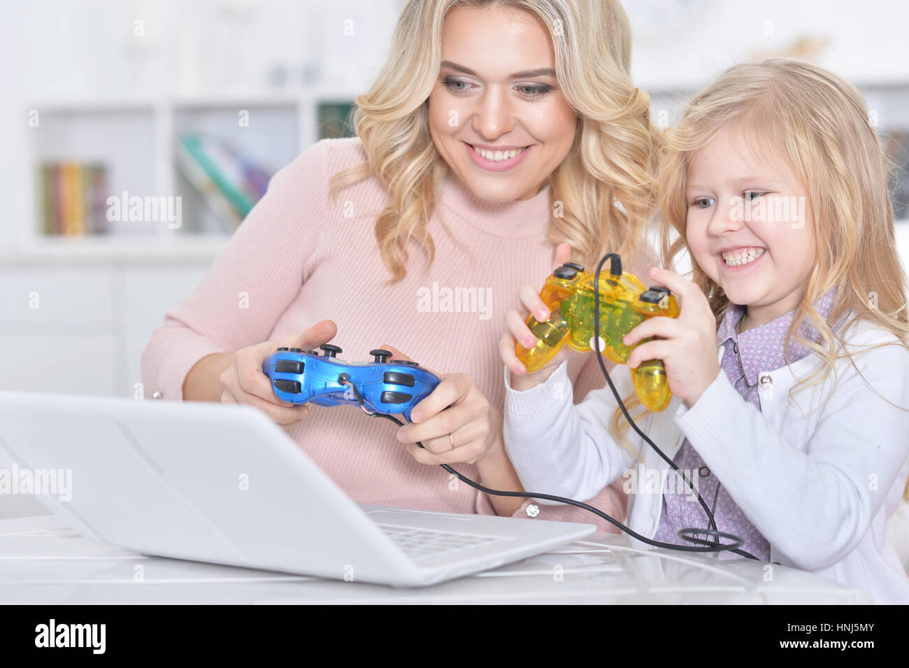 woman and girl playing video game Stock Photo - Alamy