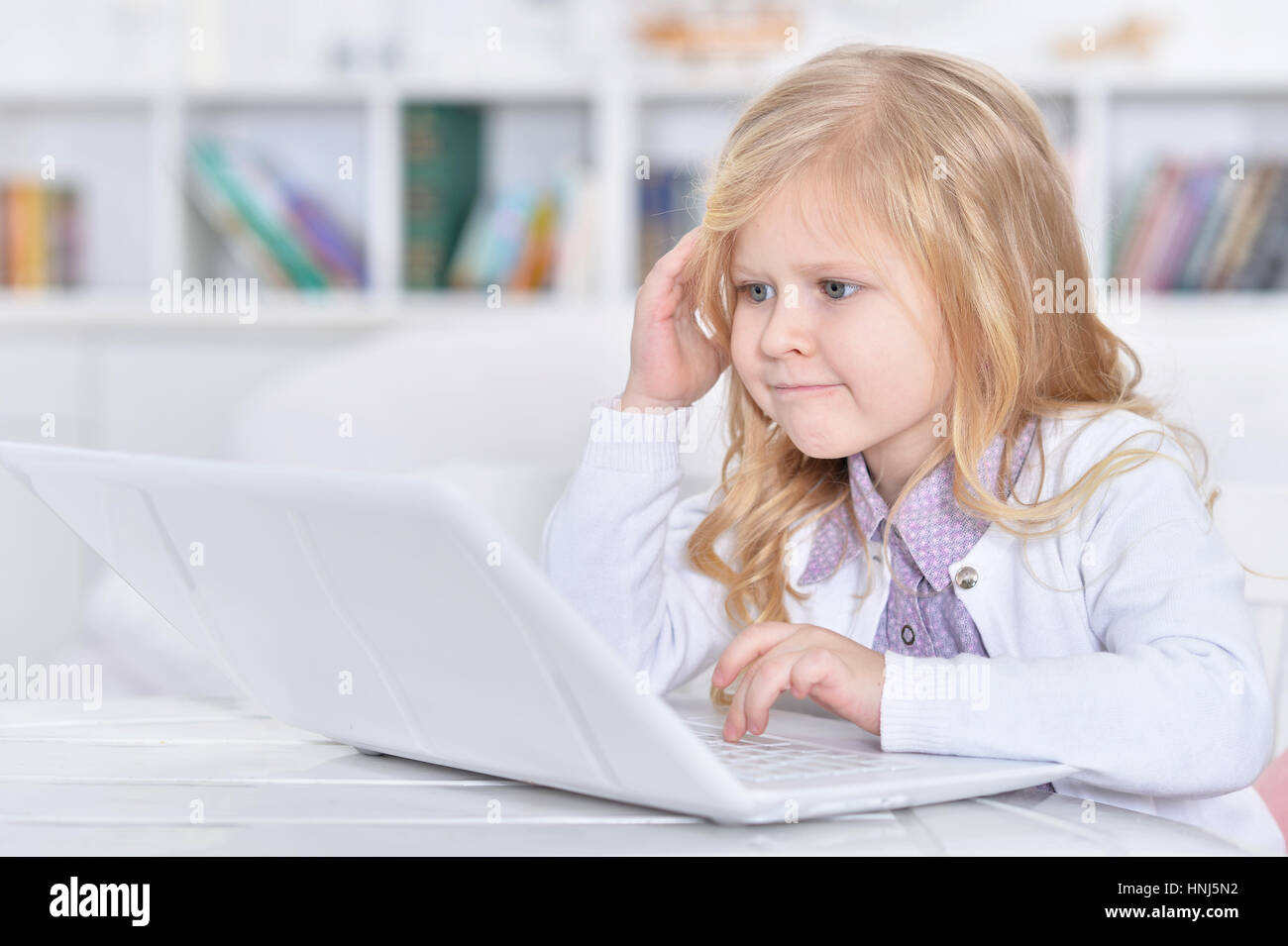 Little girl using laptop Stock Photo - Alamy