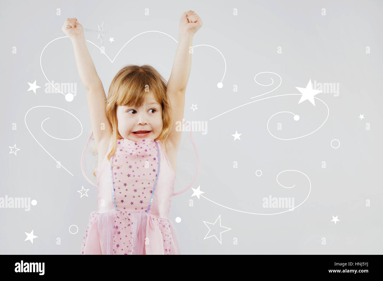 Cheerful little girl with magic stick Stock Photo - Alamy