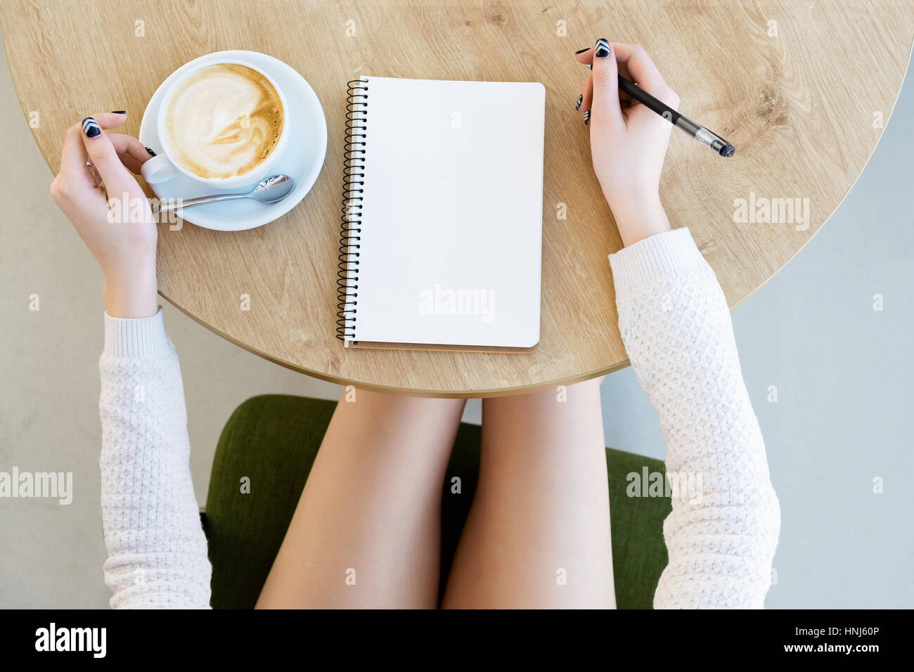 Womans hand writing in notebook hi-res stock photography and images - Alamy