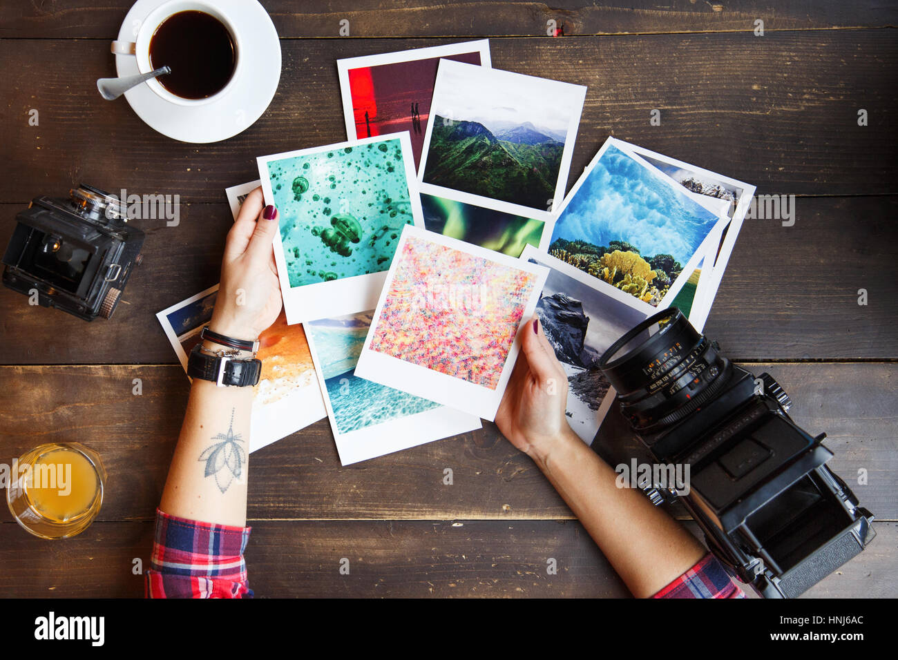 Top view of women's hands holding printed photos Stock Photo - Alamy