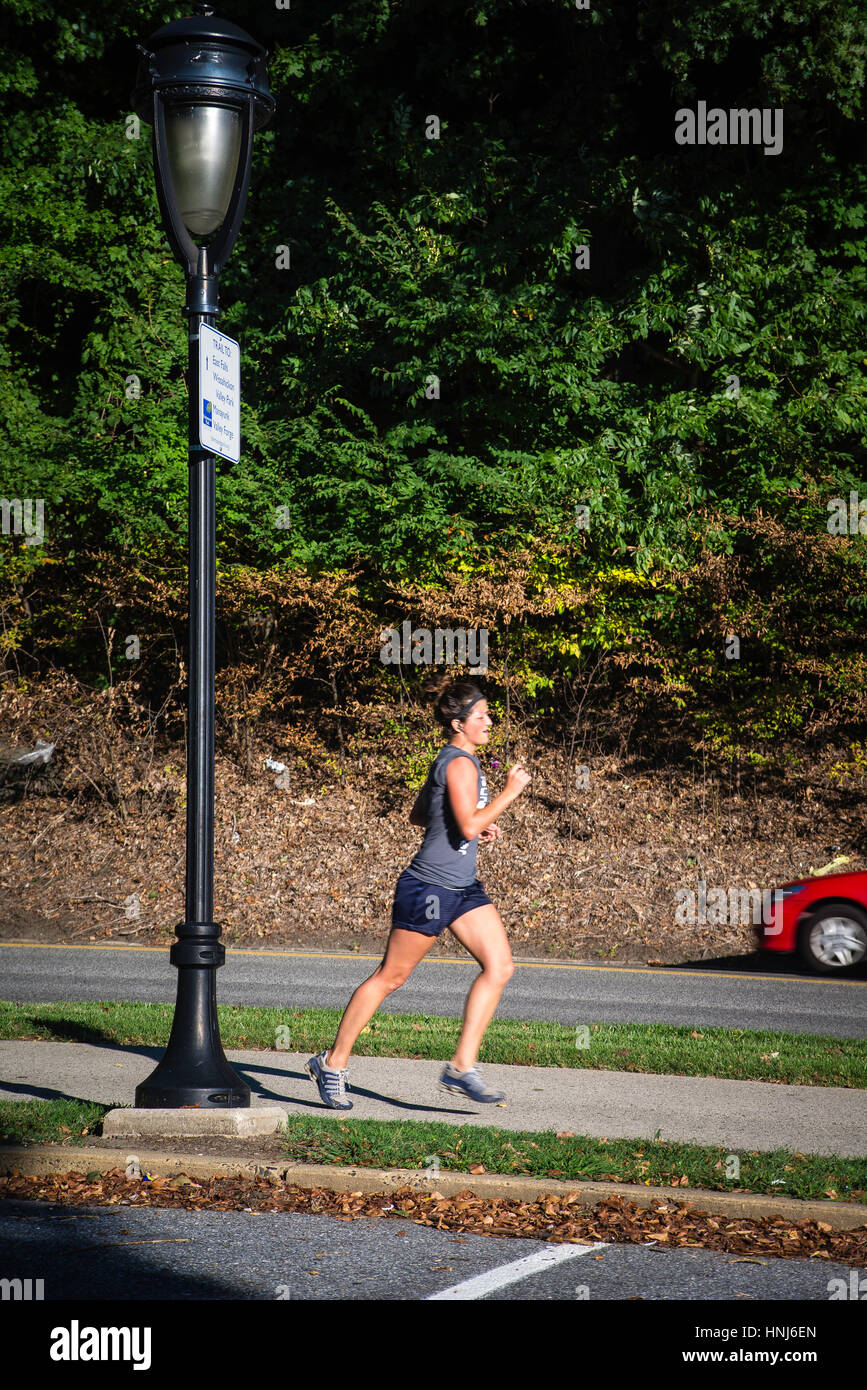 Jogger running in Philadelphia, PA park Stock Photo - Alamy