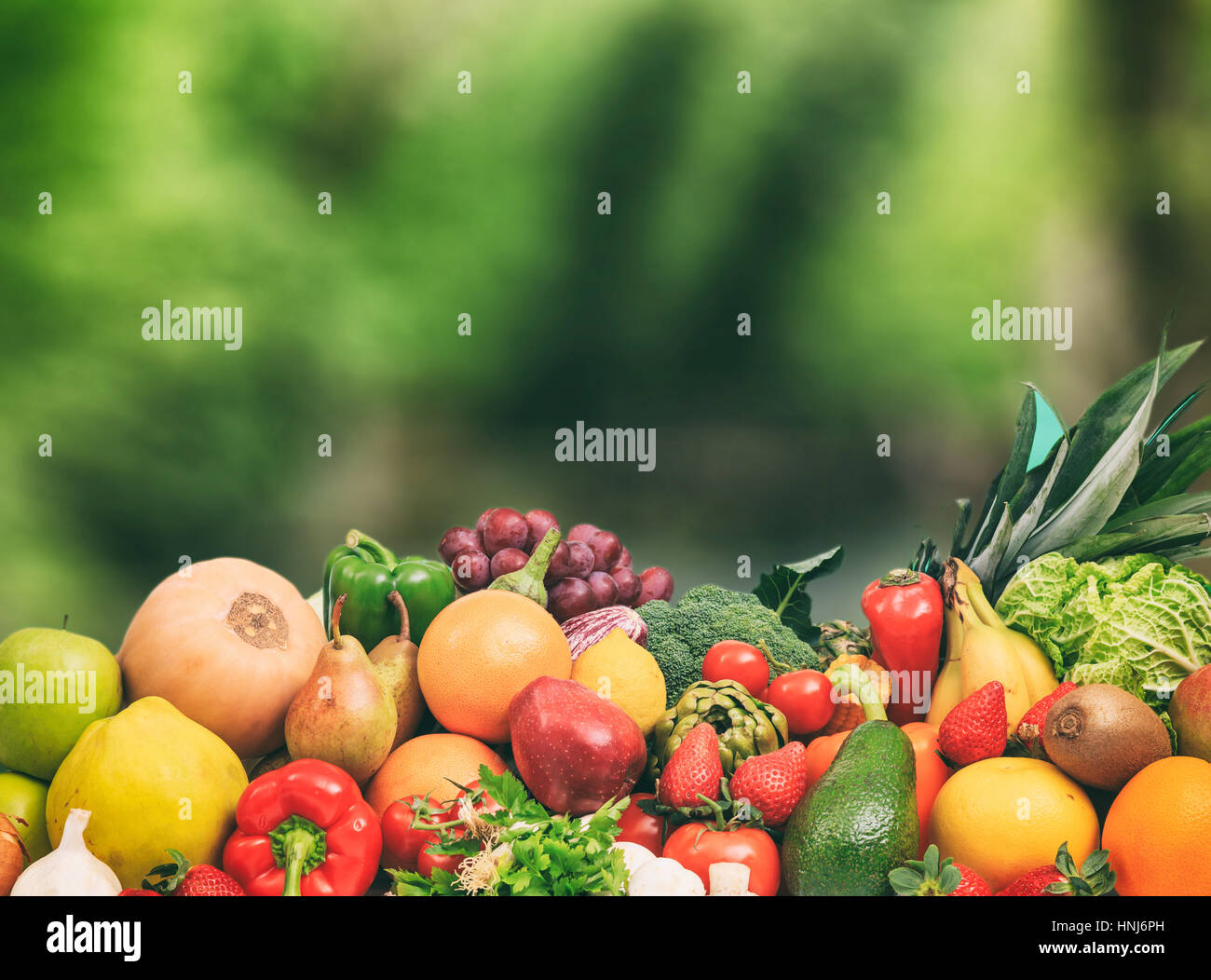 Variety of fresh fruits and vegetables on nature background Stock Photo ...