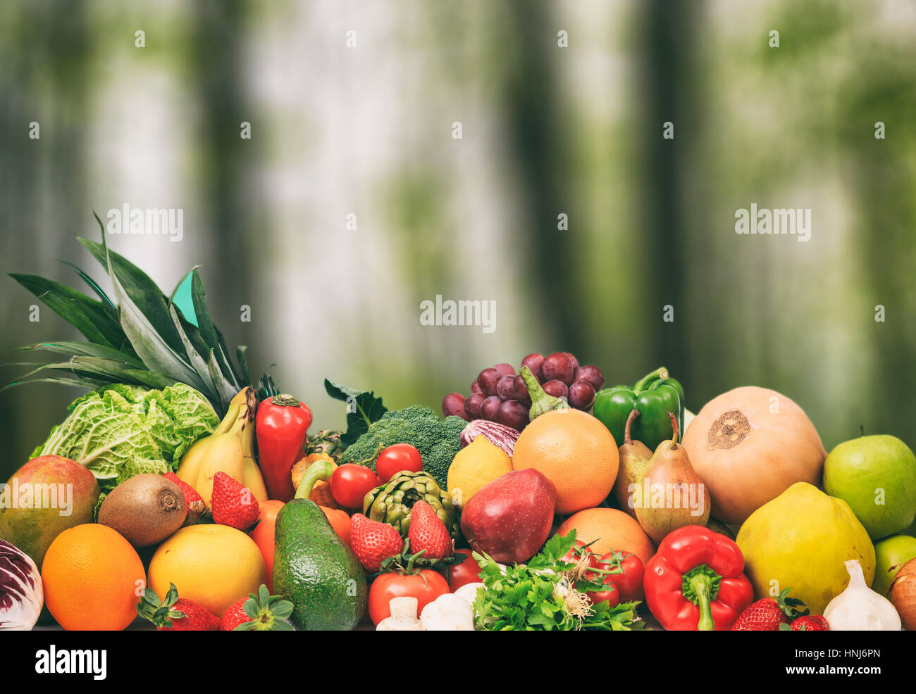 Variety of fresh fruits and vegetables on nature background Stock Photo ...