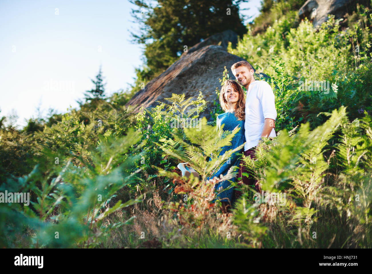 Smiling couple among trees Stock Photo - Alamy