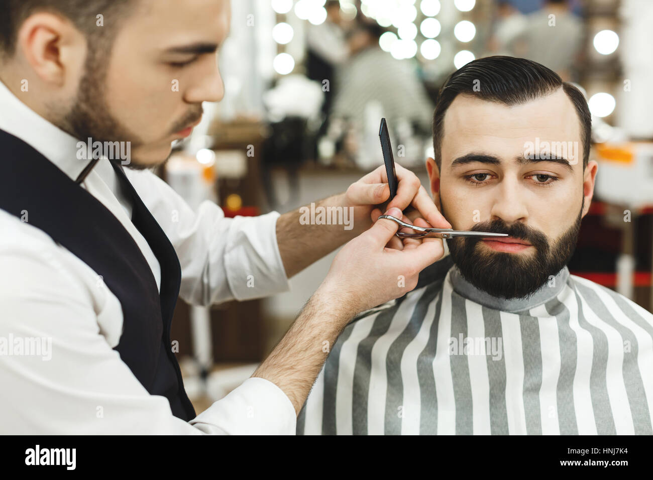Barber making a beard Stock Photo - Alamy
