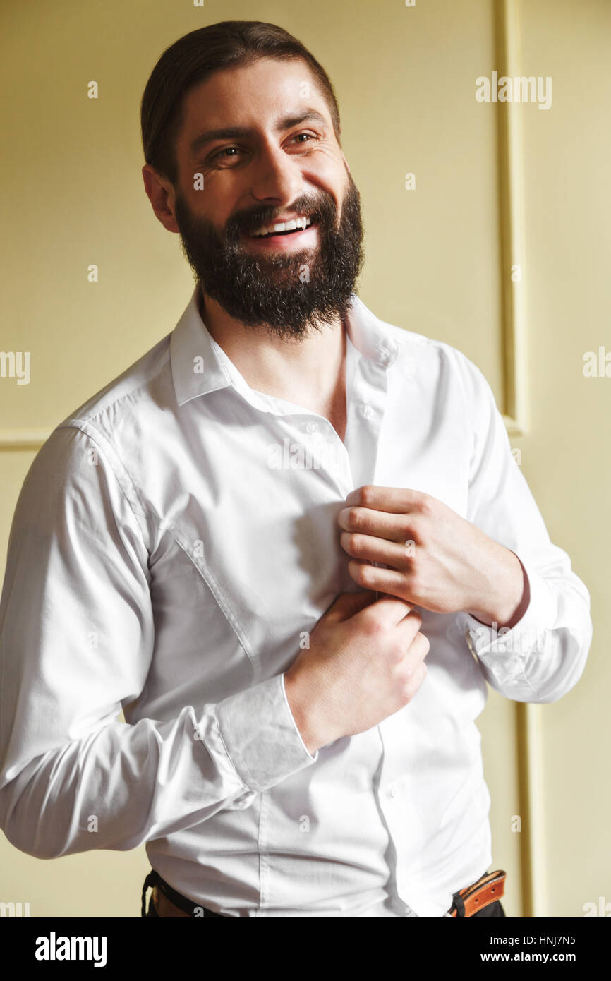 Man buttoning his shirt Stock Photo - Alamy