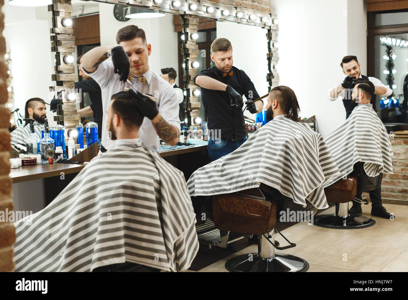 Men at barber shop doing haircuts Stock Photo - Alamy