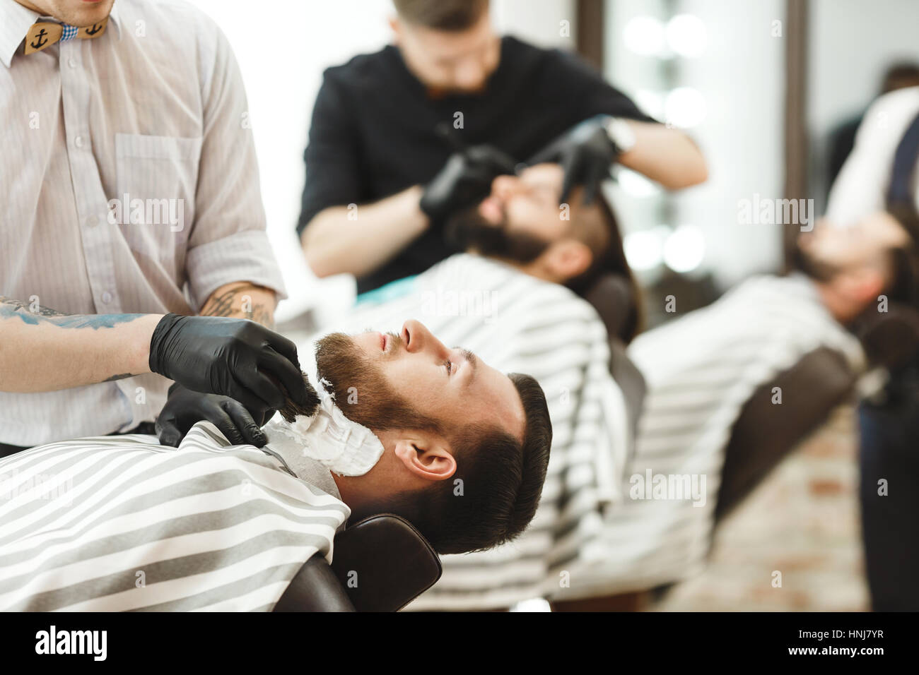 Barbers making a beard form for clients Stock Photo - Alamy