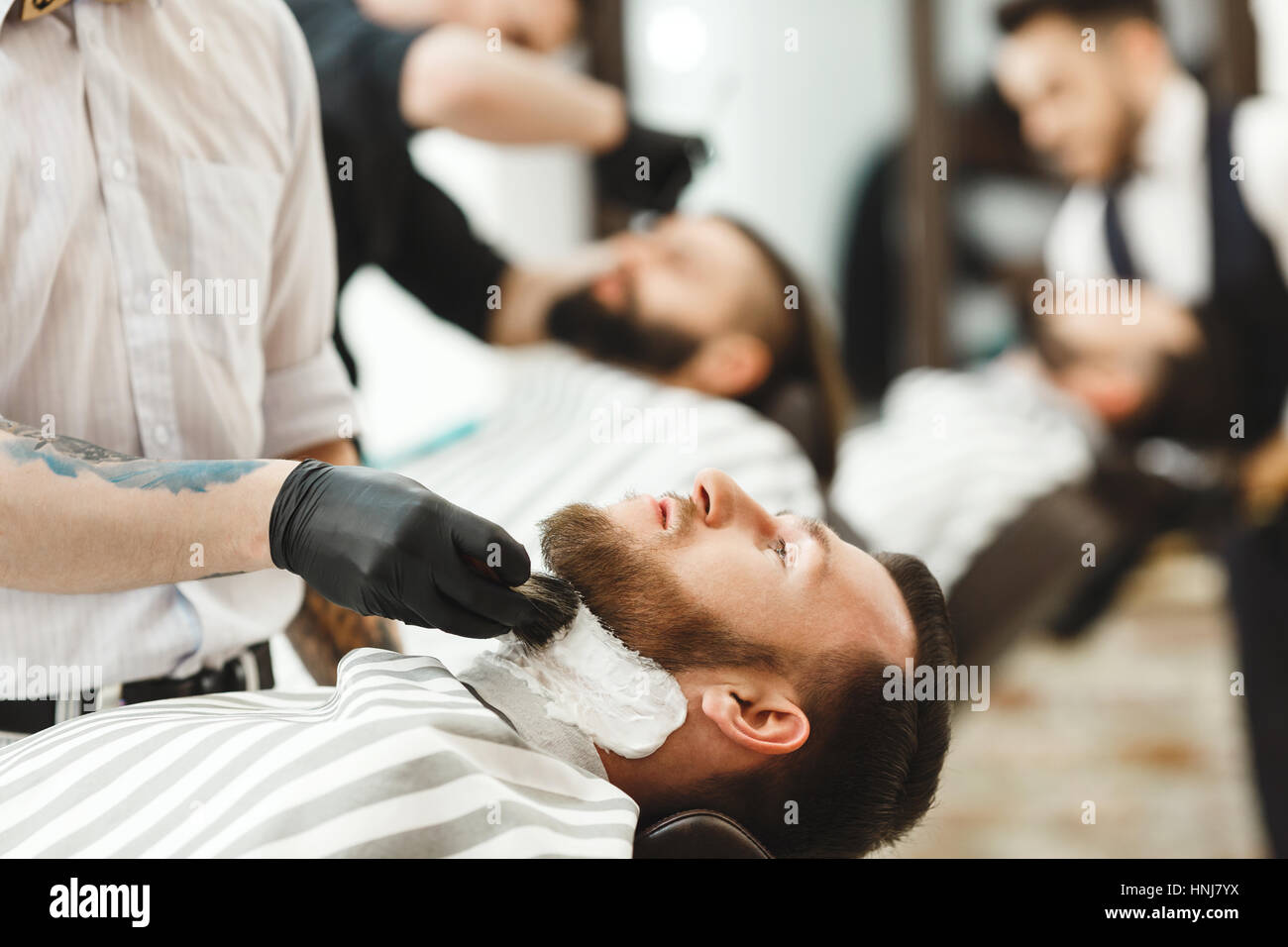 Barbers making a beard form for clients Stock Photo - Alamy