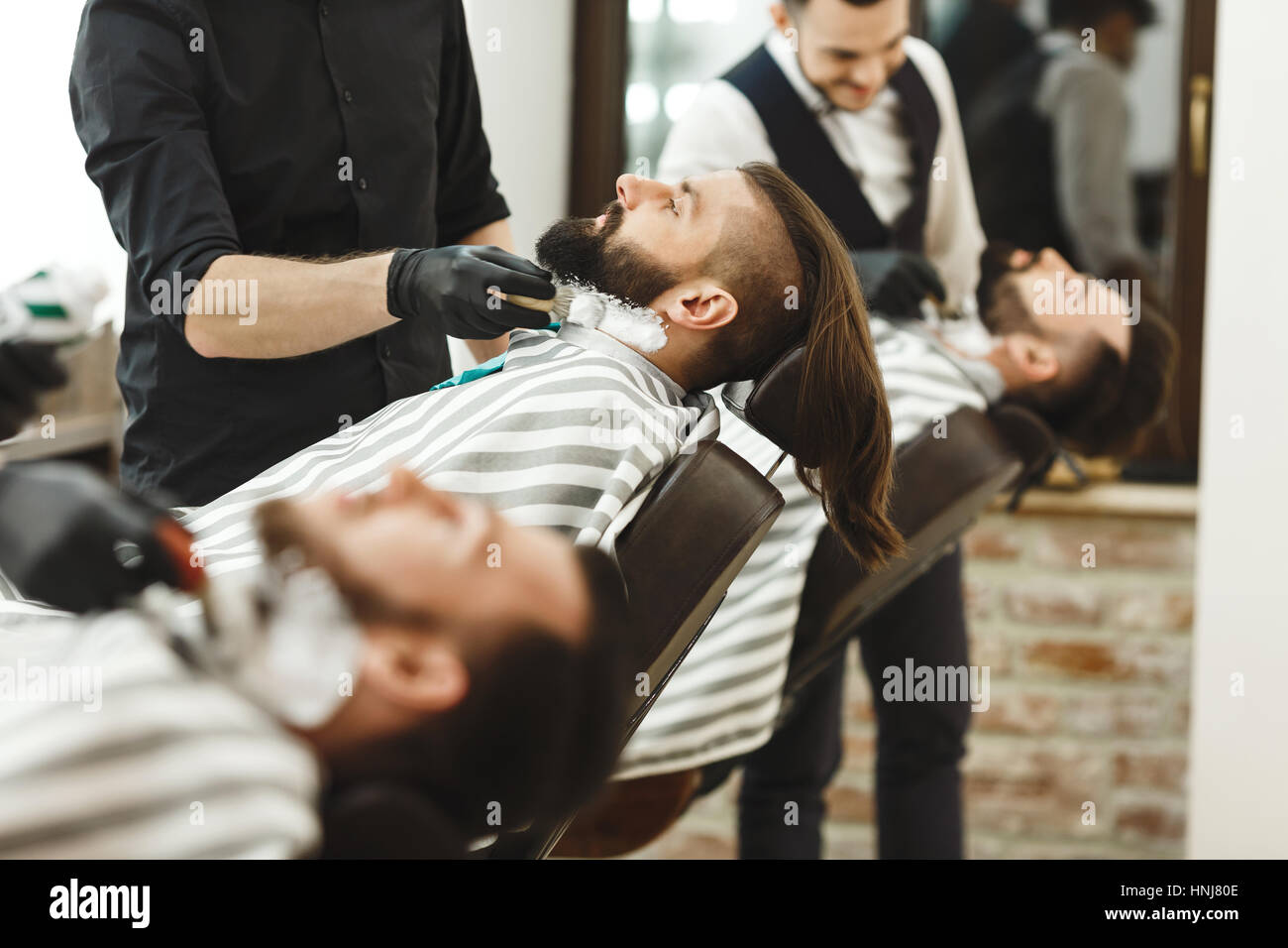 Barbers making a beard form for clients Stock Photo - Alamy