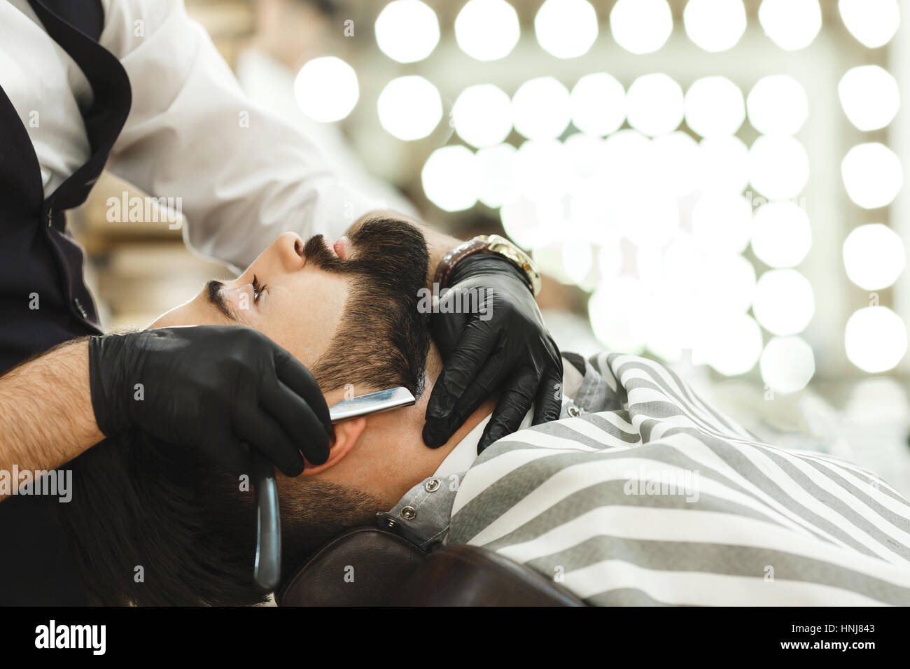 Hands in gloves making beard form Stock Photo - Alamy