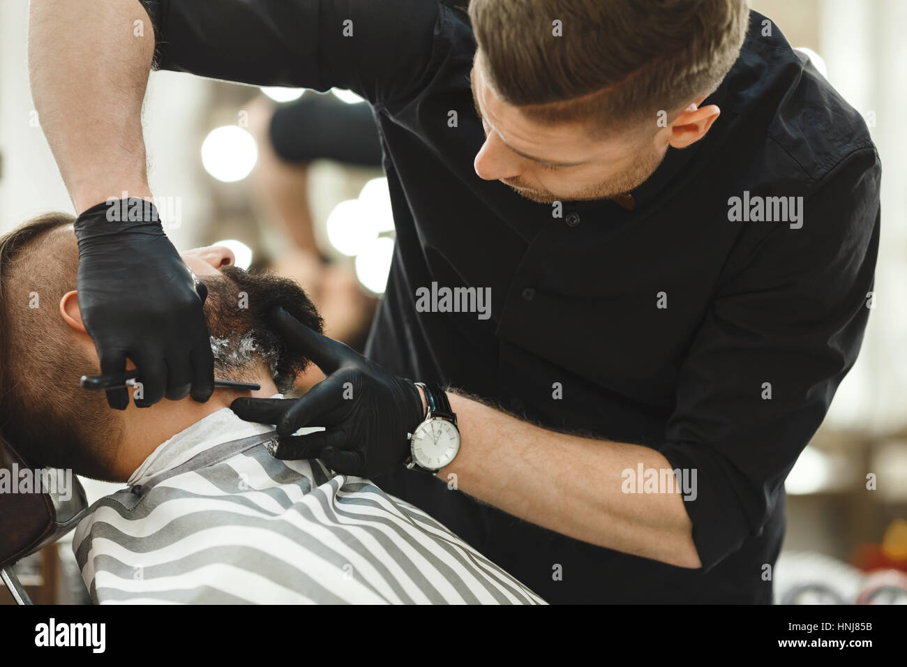 Barber making beard form for man Stock Photo - Alamy
