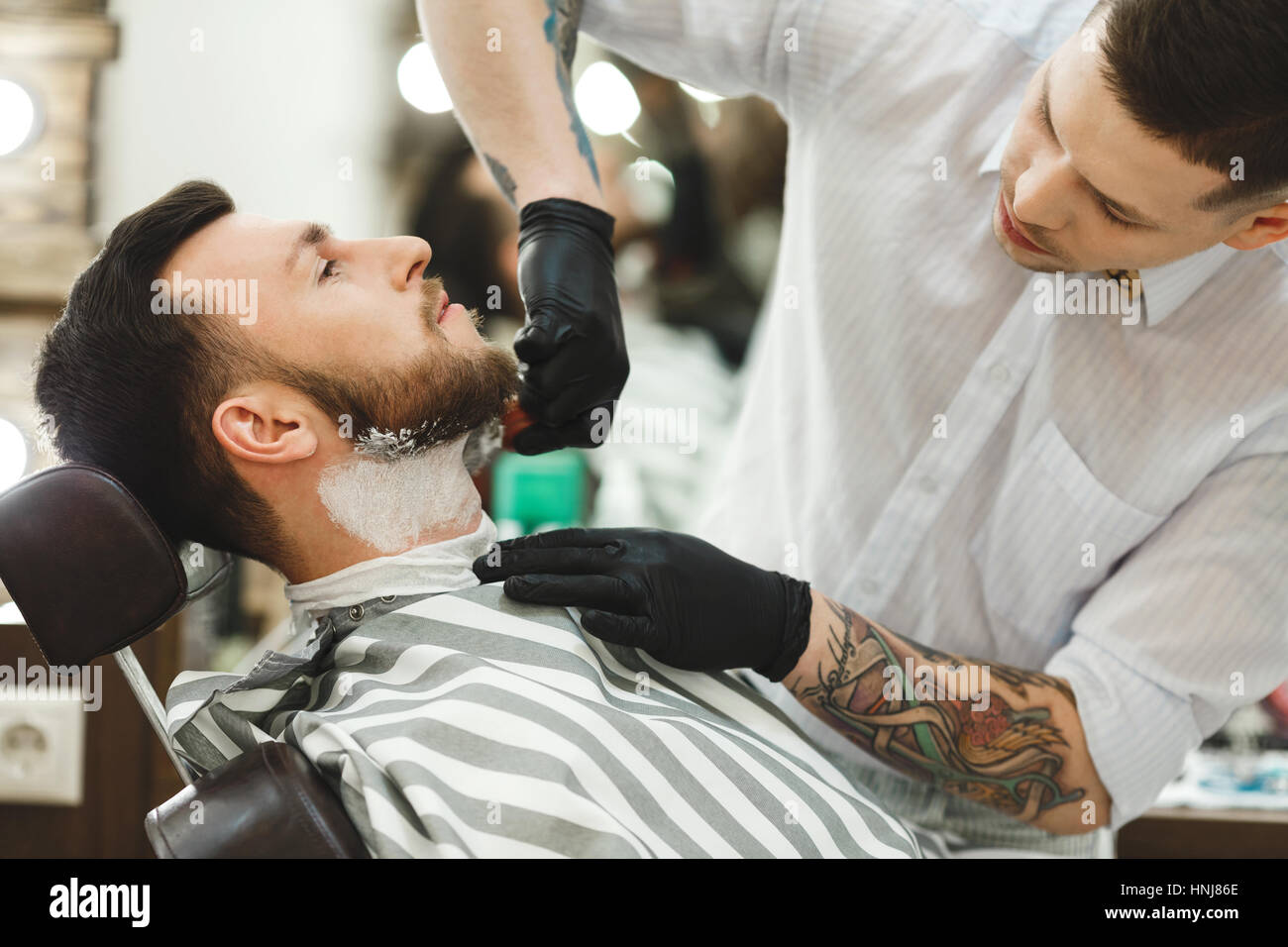 Barber making beard form for man Stock Photo - Alamy