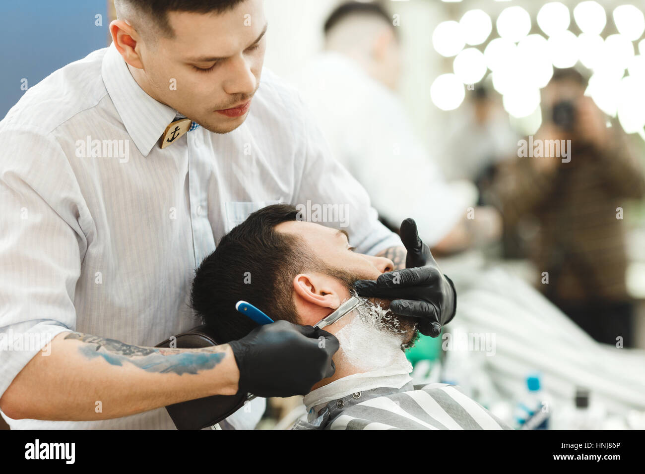 Barber making beard form for man Stock Photo - Alamy