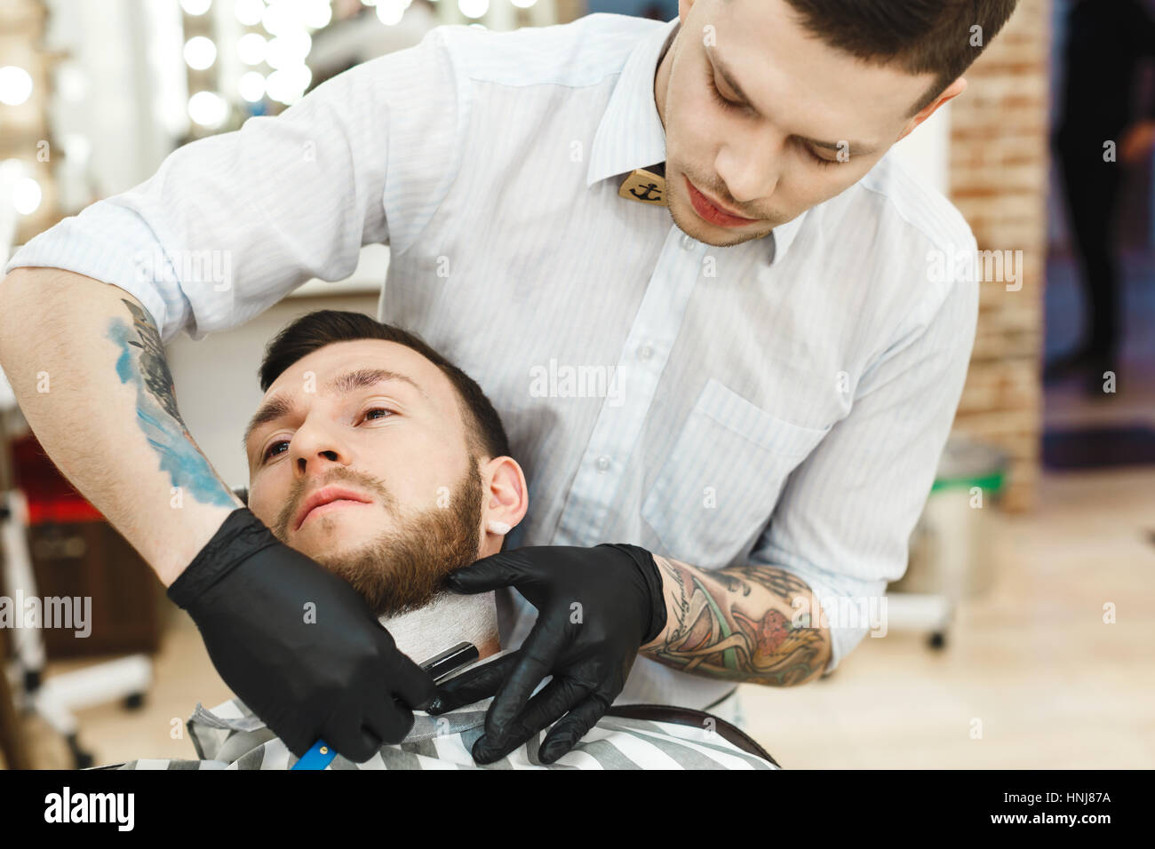 Barber making beard form for man Stock Photo - Alamy