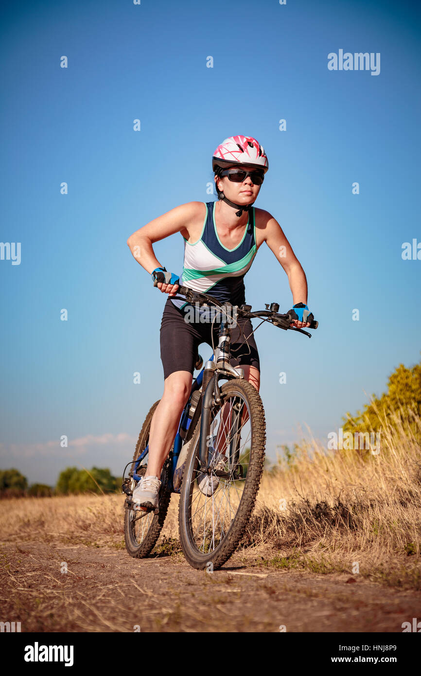 Women on the nature of riding a bike Stock Photo - Alamy