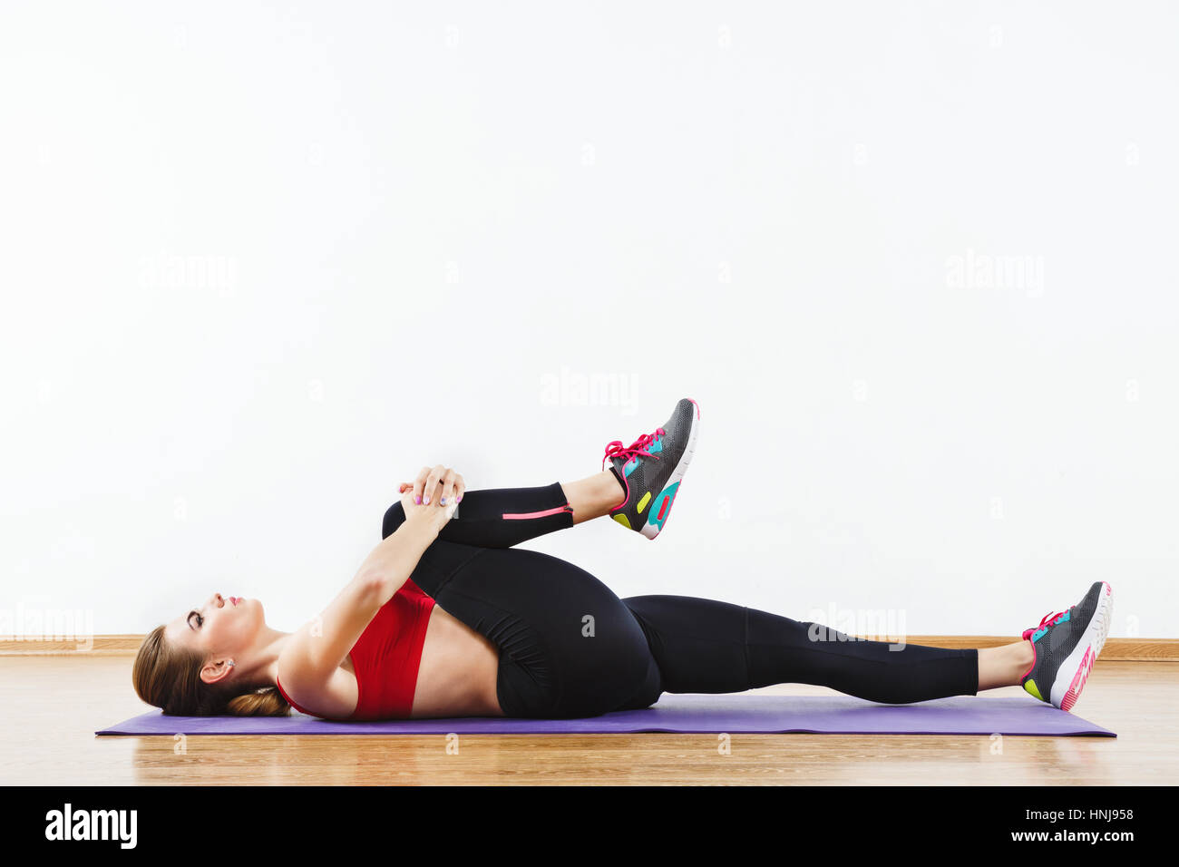 Attractive fit girl doing physical exercises at gym Stock Photo - Alamy