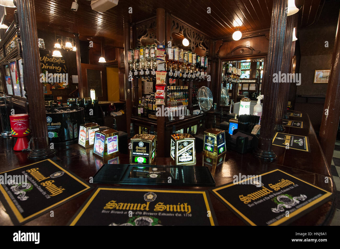 An interior of an old London pub with amazing stained glass windows ...