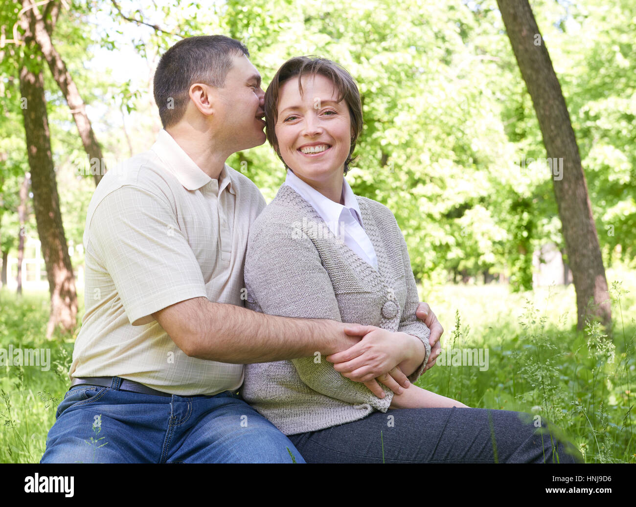 Happy couple portrait. City park in summer season. Beautiful landscape ...
