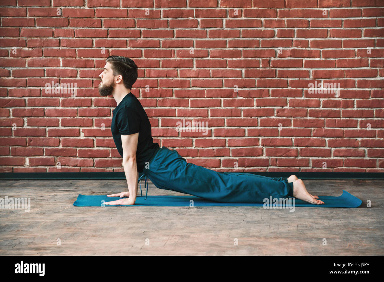 Handsome man doing yoga positions Stock Photo - Alamy