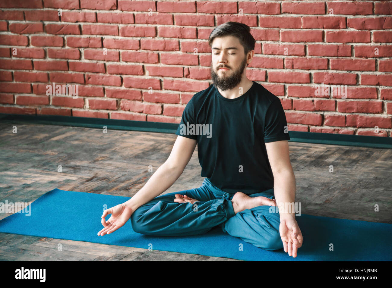 Handsome man doing yoga positions Stock Photo - Alamy