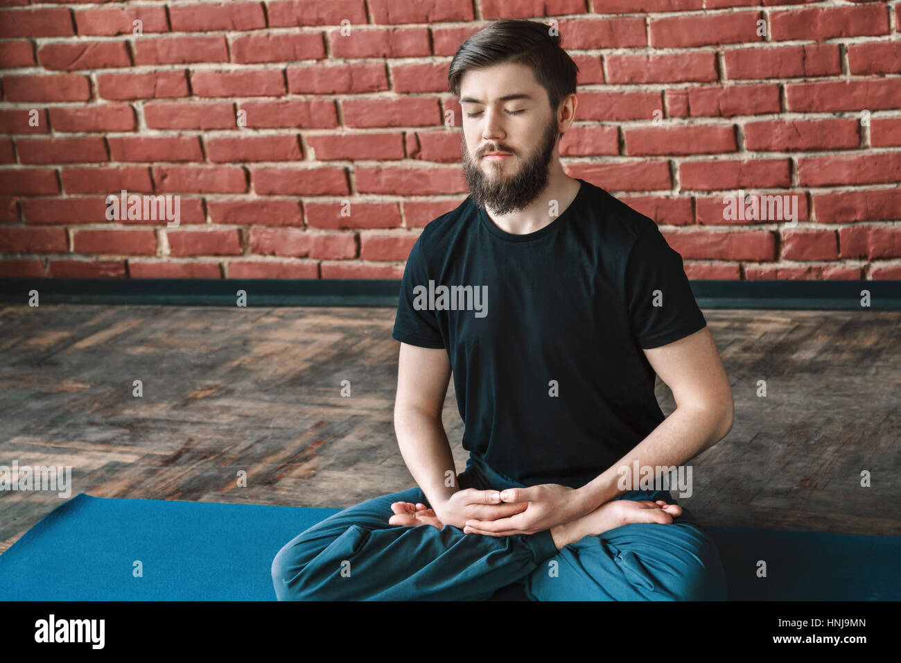 Handsome man doing yoga positions Stock Photo - Alamy
