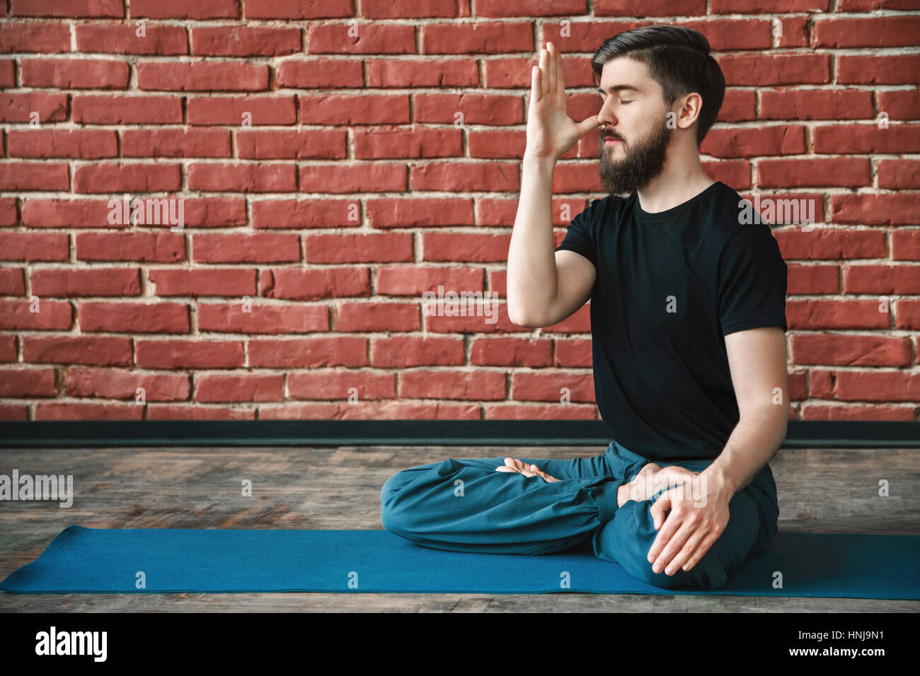 Handsome man doing yoga positions Stock Photo - Alamy